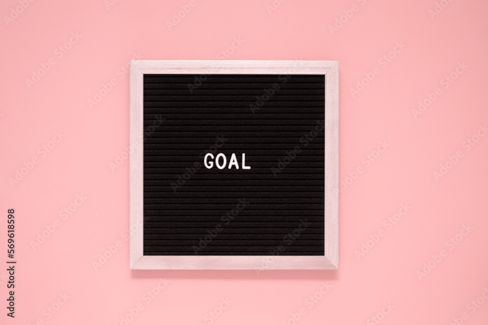 White color letter in word goal on black felt board background ...