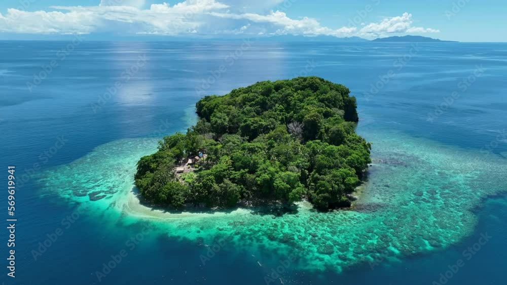 An idyllic, remote island is surrounded by coral reef in the Solomon ...
