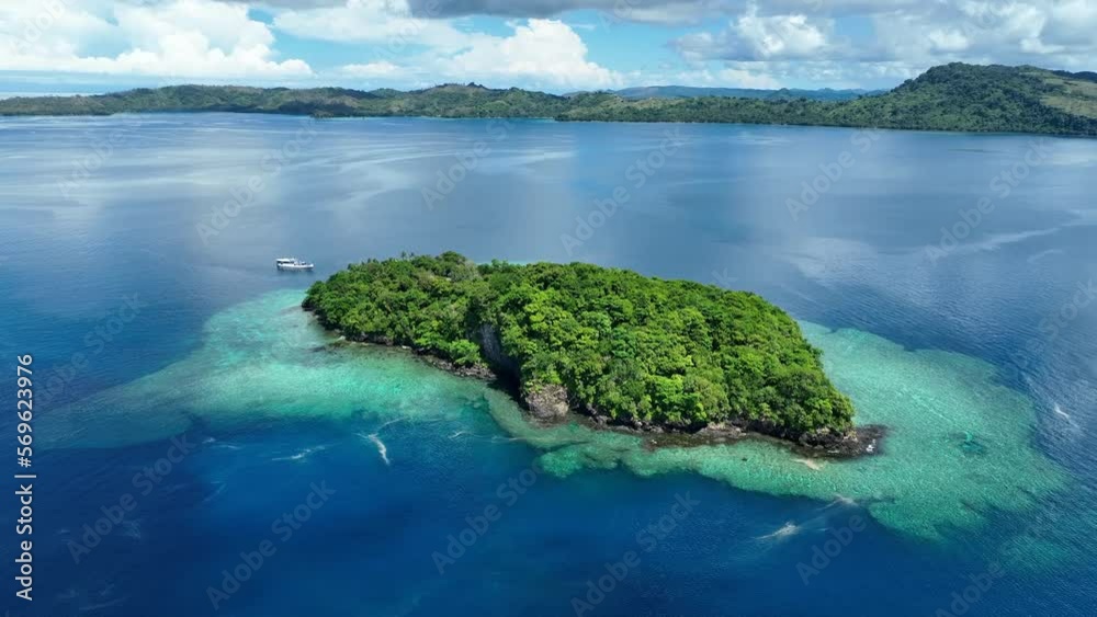 An idyllic, remote island is surrounded by coral reef in the Solomon ...