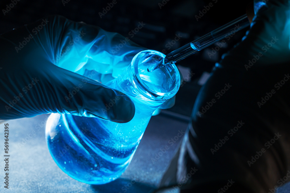 Blue science experiment glass tube,Researchers with chemistry test ...