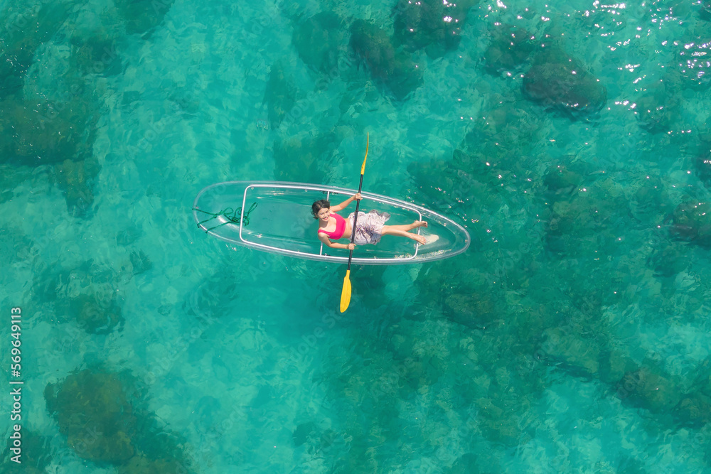 Aerial top view of Asian woman, a tourist, paddling a boat, canoe ...