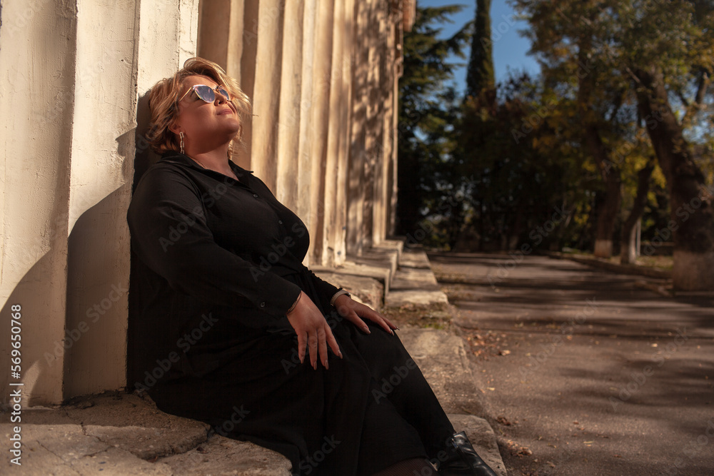 Beautiful woman plus size is walking around the city. The adult woman ...