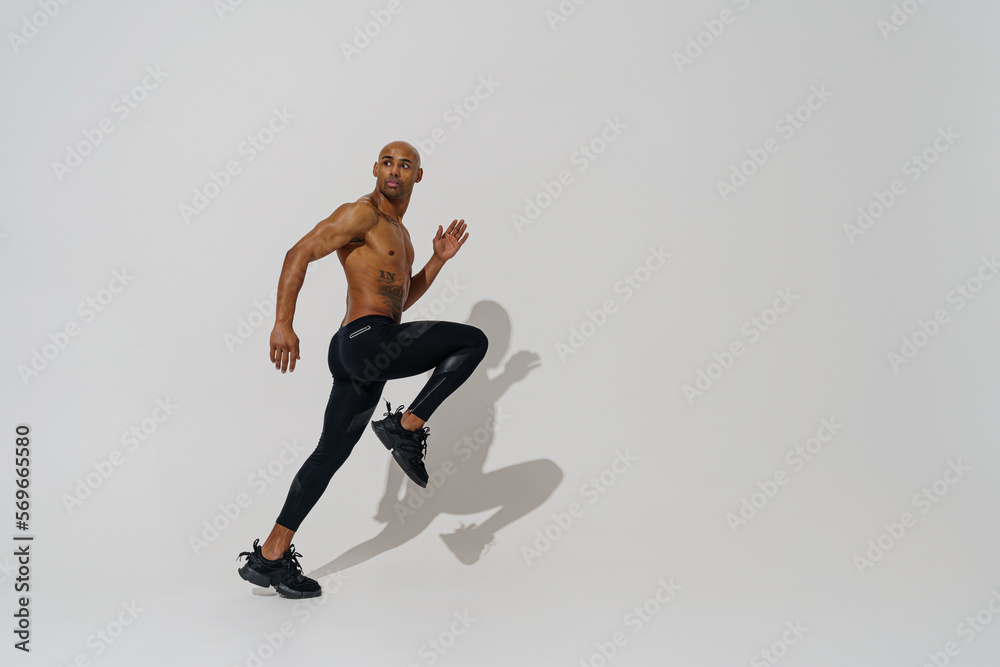 Professional male athlete running isolated on white studio background ...