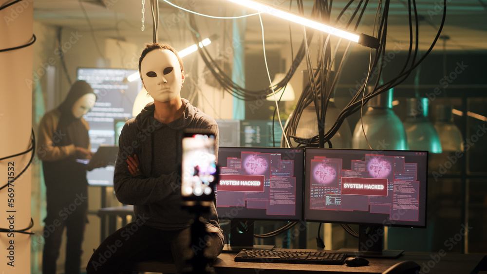 Female hacker with mask broadcasting live threat video, asking for ...