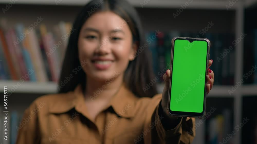 Close-up smiling korean woman businesswoman holding phone showing green ...