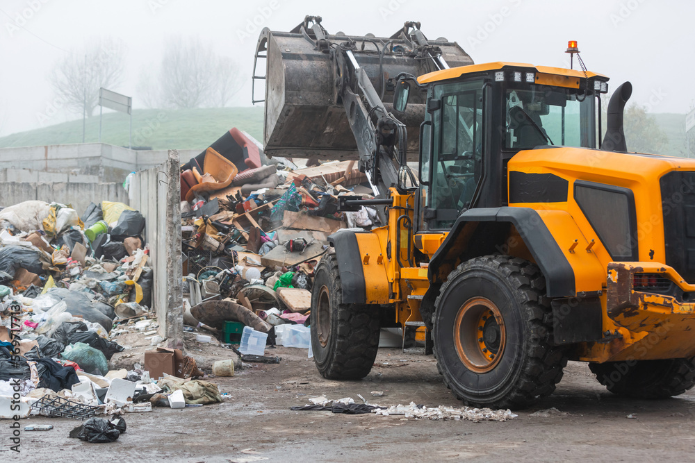 Front loader with scrap handling grapple bucket moving forward and ...