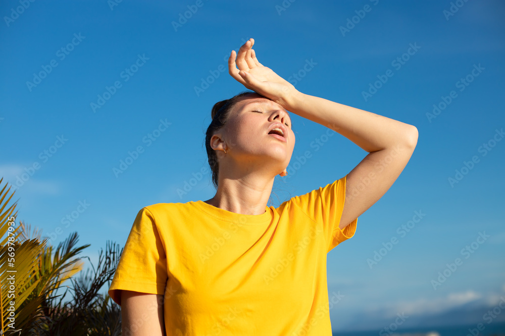 Girl is suffering from heat, woman with heatstroke. Having sunstroke at ...