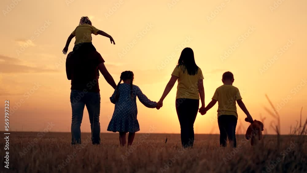 Vídeo do Stock: Happy family walk in wheat field. People holding hands ...