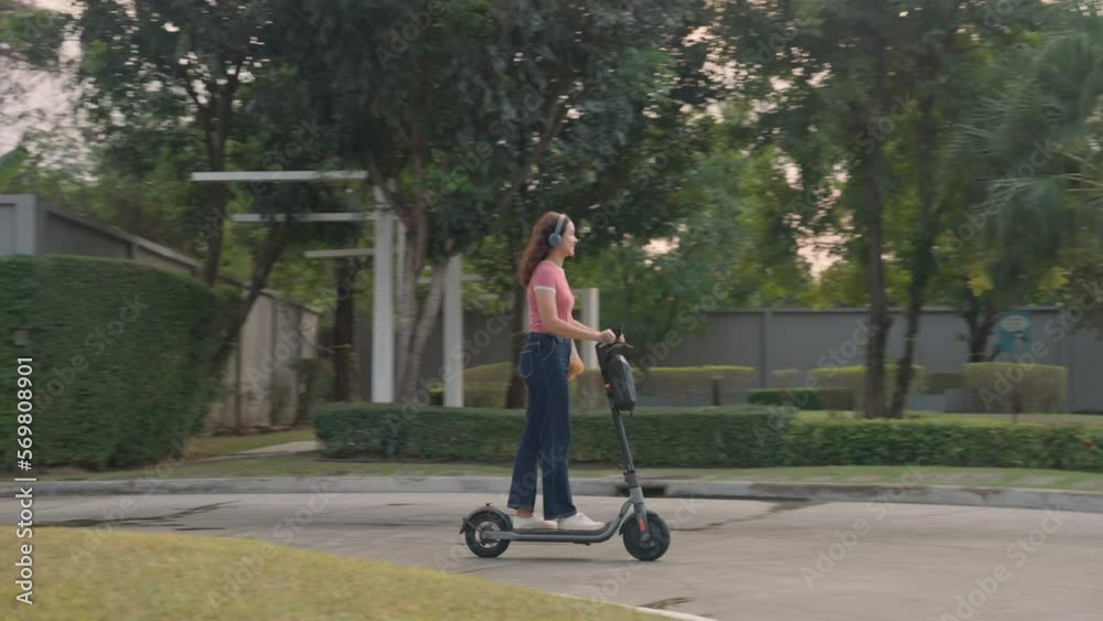 Young woman happy smile girl go green asia people ride EV bike push ...