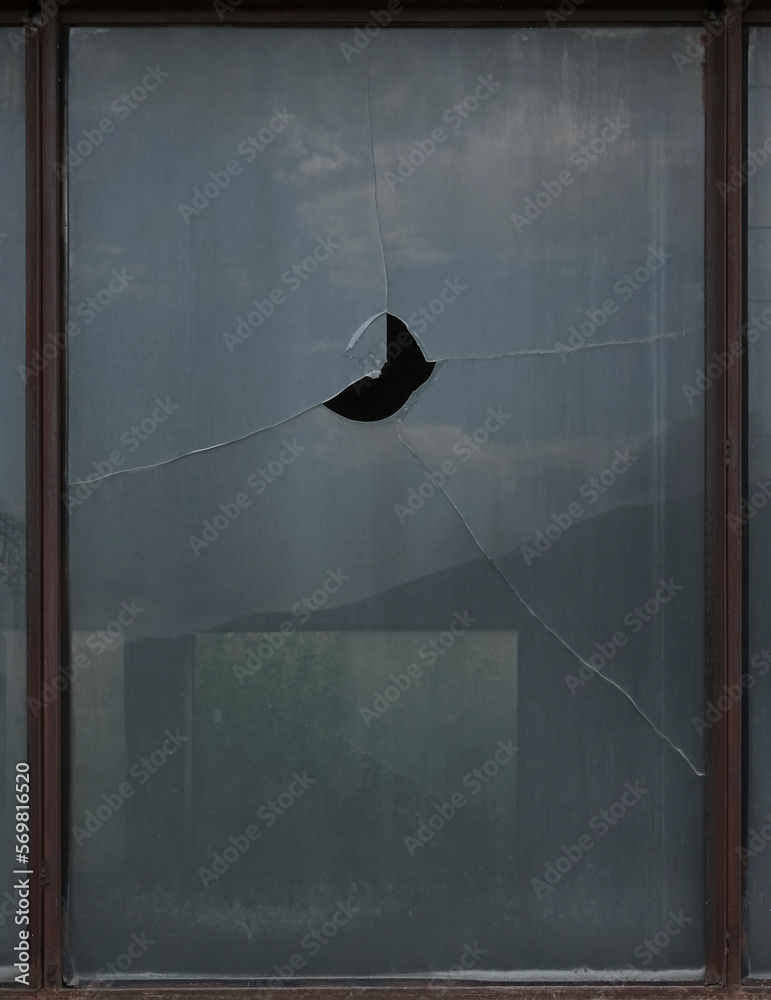 Ruined industrial building. metal window frame with hole in broken ...