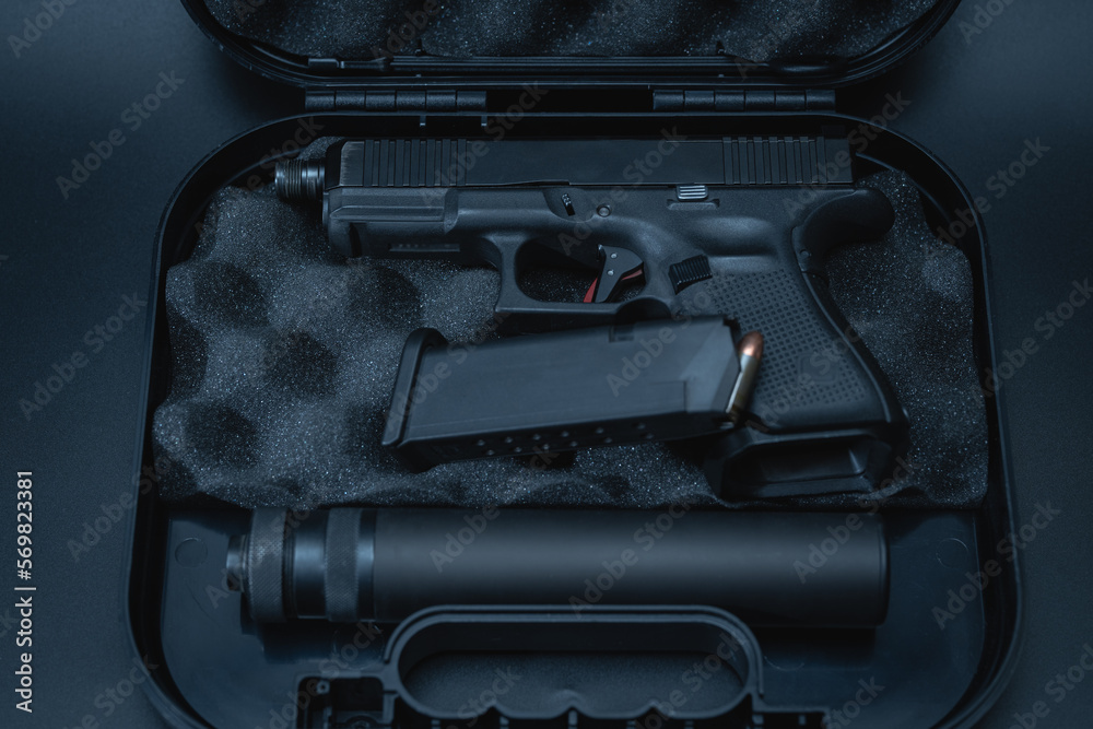 Pistol with a silencer in a case. Stock Photo | Adobe Stock