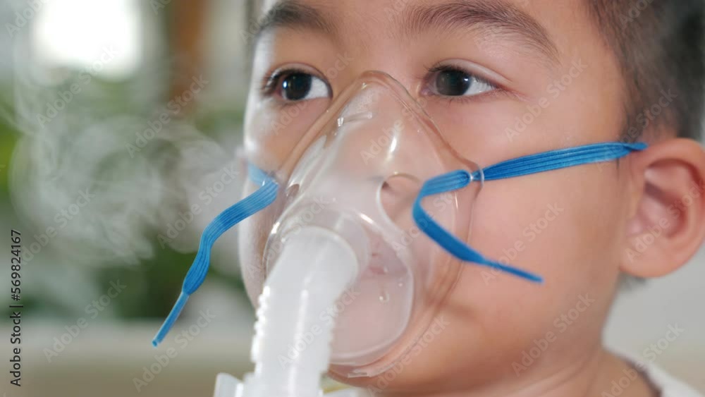 Asian Child using nebulizer mask equipment alone have smoke, Kid boy ...