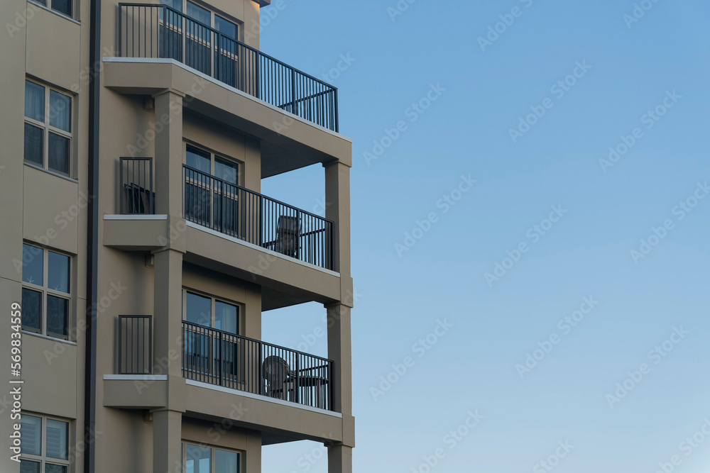 Modern multi-storey apartment or hotel building with corner balconies ...