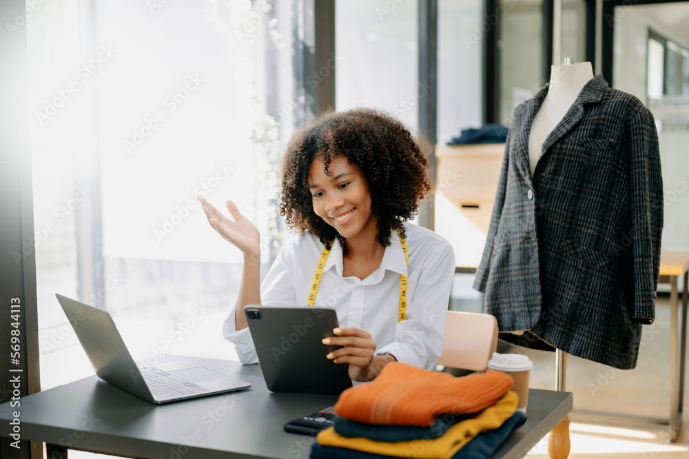 African tailor woman working on clothes in tailoring atelier. beautiful ...