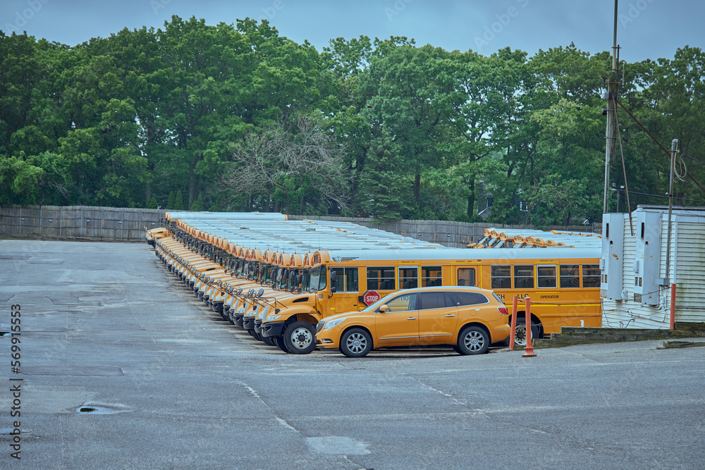 Long line of yellow american school buses in the parking lot empty ...