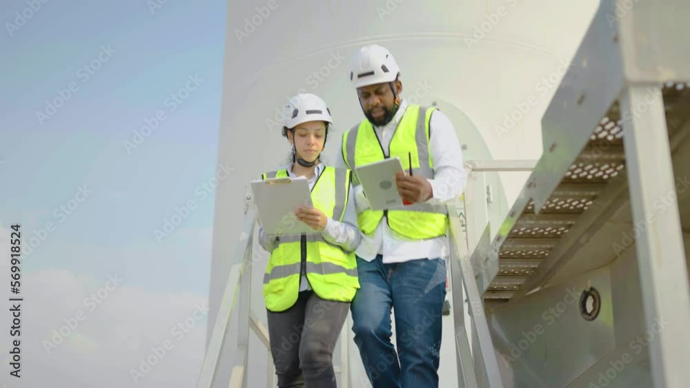Two engineers african american man and woman in uniform walking down ...