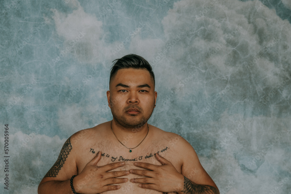 Filipino man with hands on chest looking at camera Stock Photo | Adobe ...