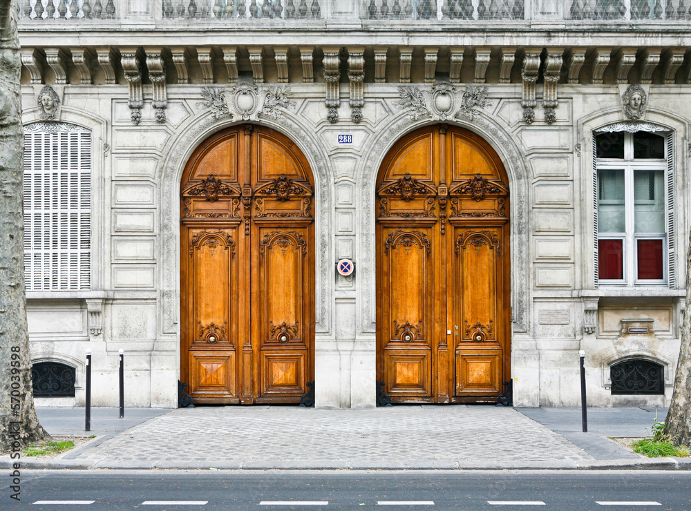 Paris ancient stone building entrance with carved doors, stone walls ...