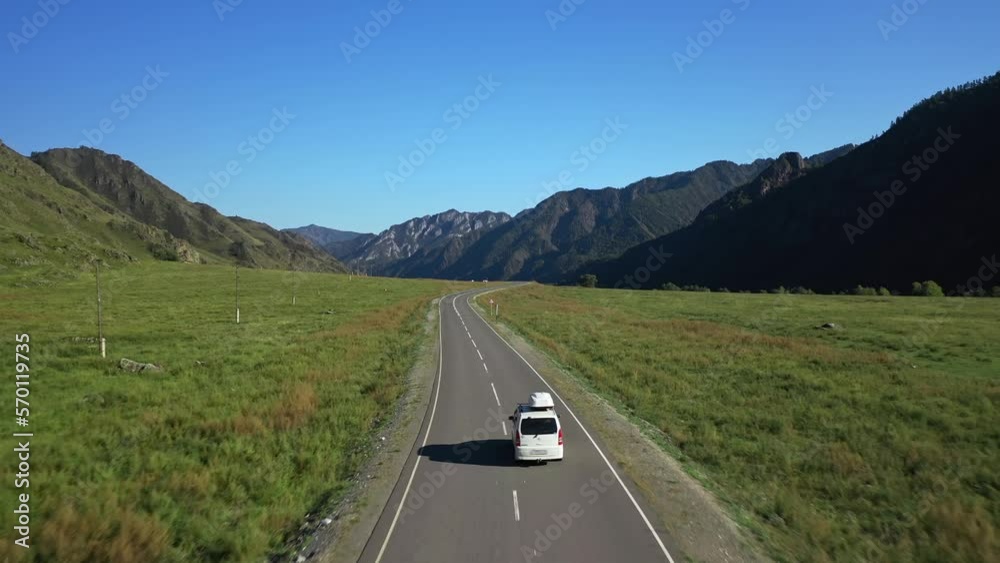 White SUV van riding on traffic asphalt road surrounded picturesque ...