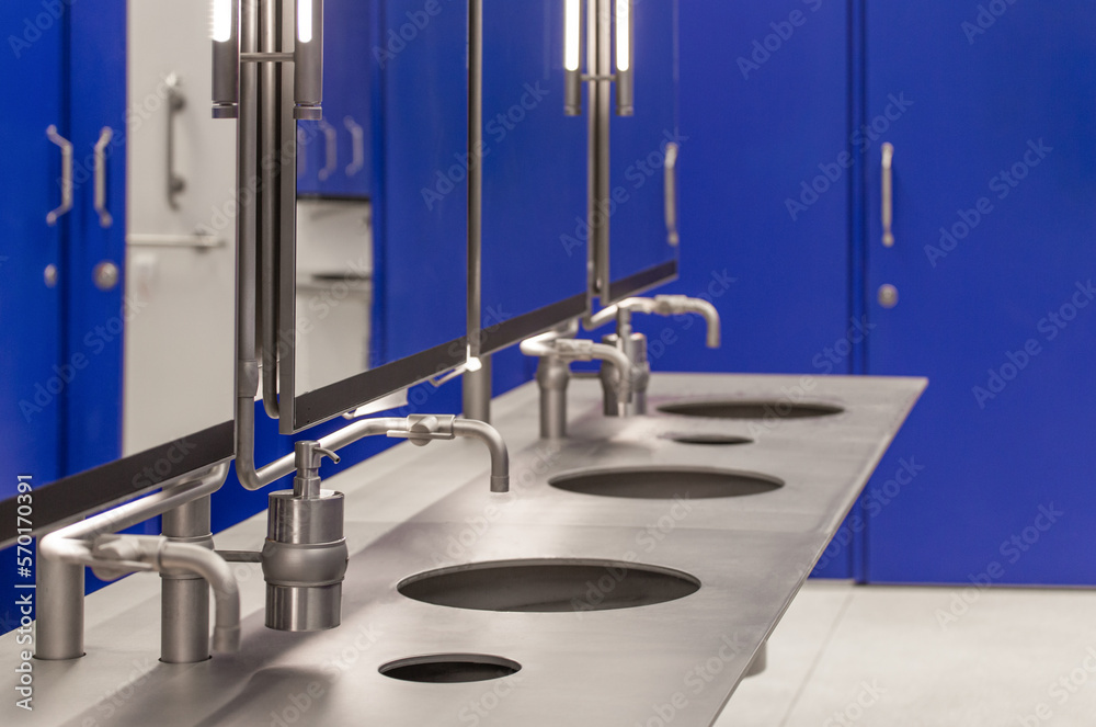 Commercial bathroom for hand washing. Faucets with a washbasin in a ...