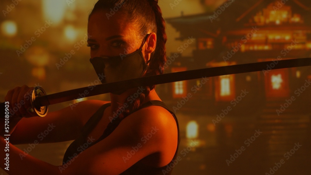 Young and beautiful ninja girl in a mask and with a katana. Samurai ...