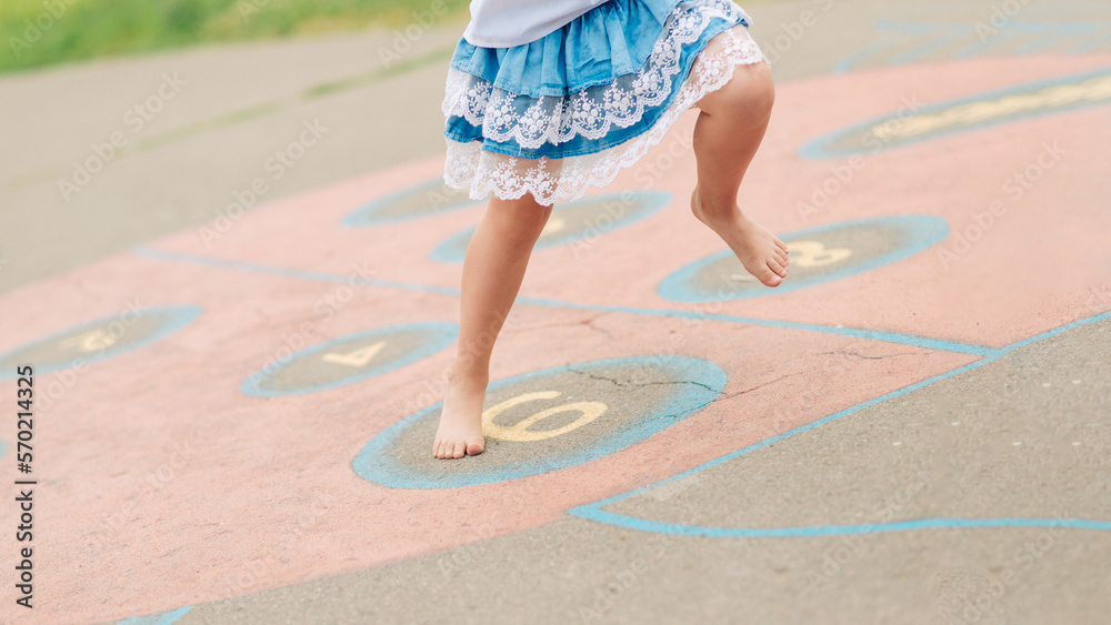 Little girl's legs jump in the park, children's play, active childhood ...