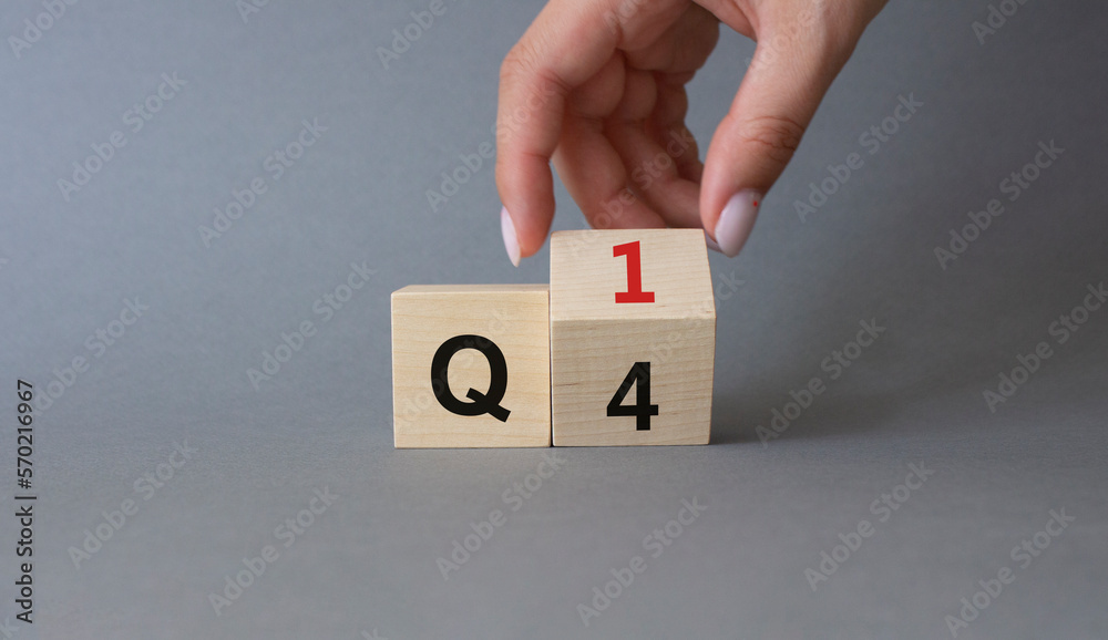 From 4th Quarter to 1st symbol. Businessman hand Turnes cube and ...