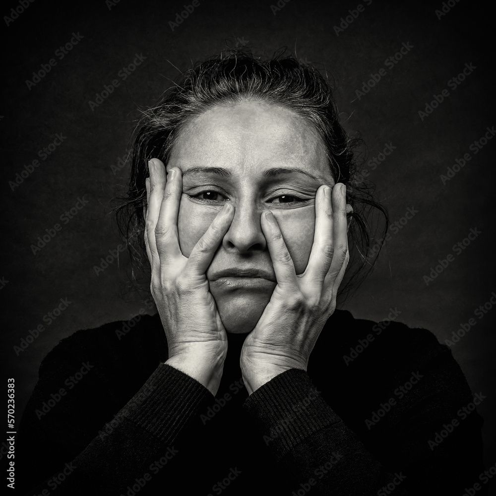 Conceptual dark portrait of old depressed woman stretching the skin of ...