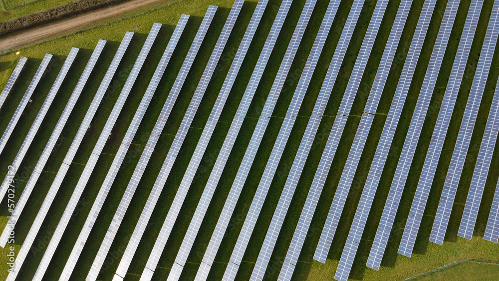 A solar panel farm with a top down aerial view. Solar panels fill most ...