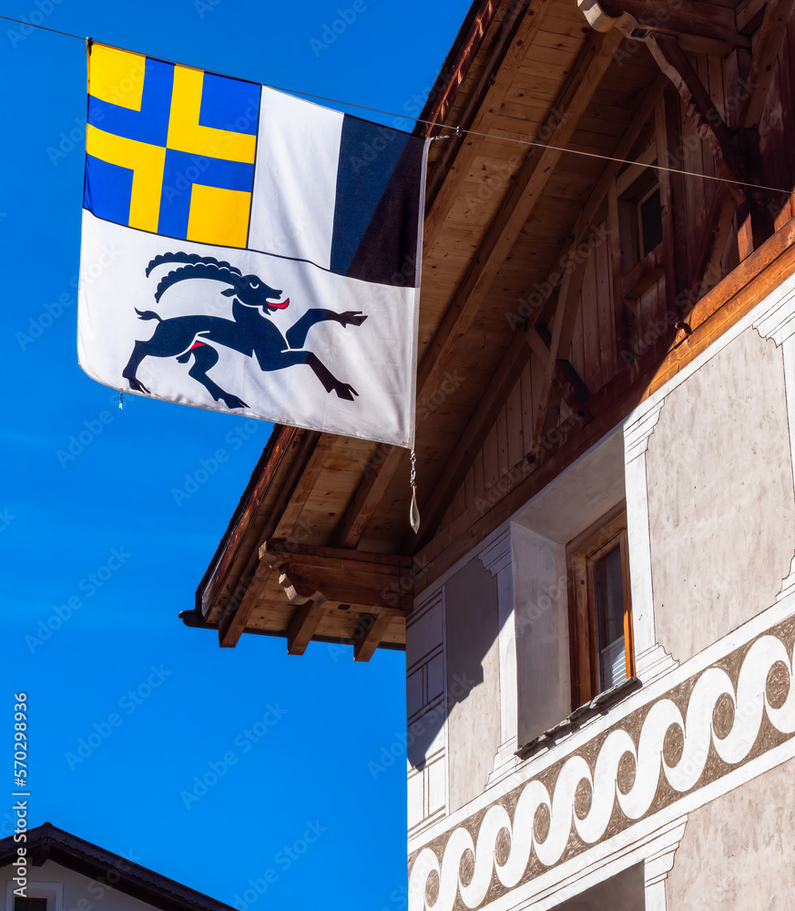Traditional historical house in Mustair with the cantonal flag of the ...
