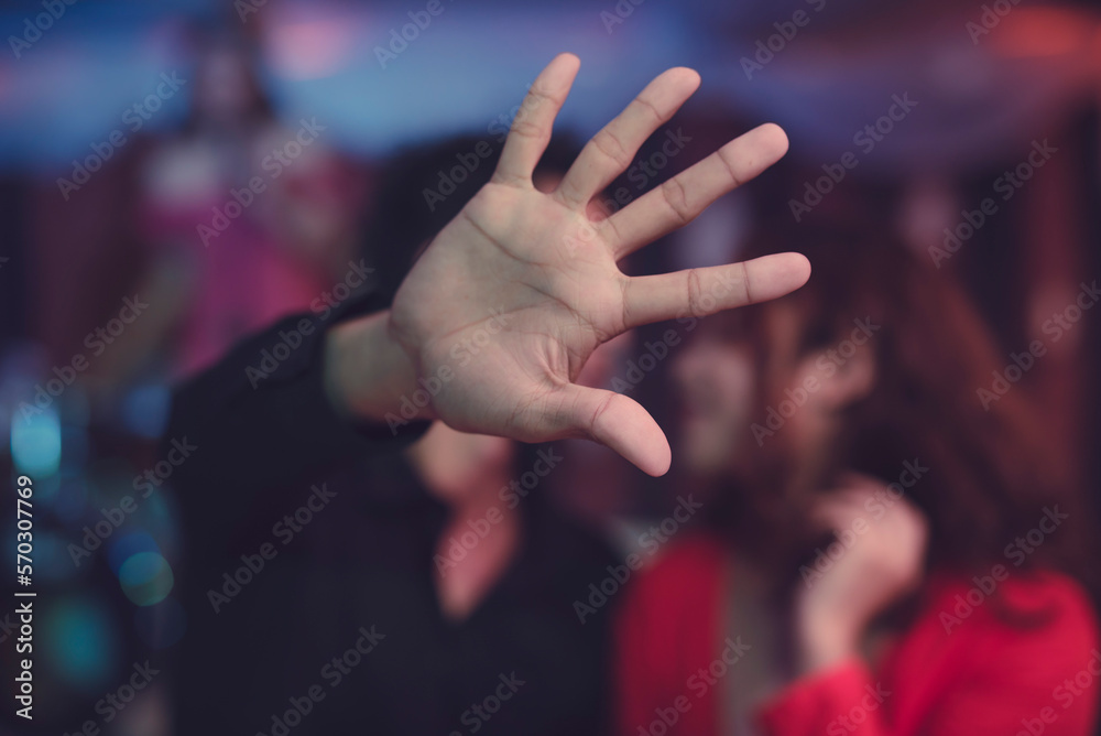 A man puts his hand out to cover the lens of the camera to prevent ...