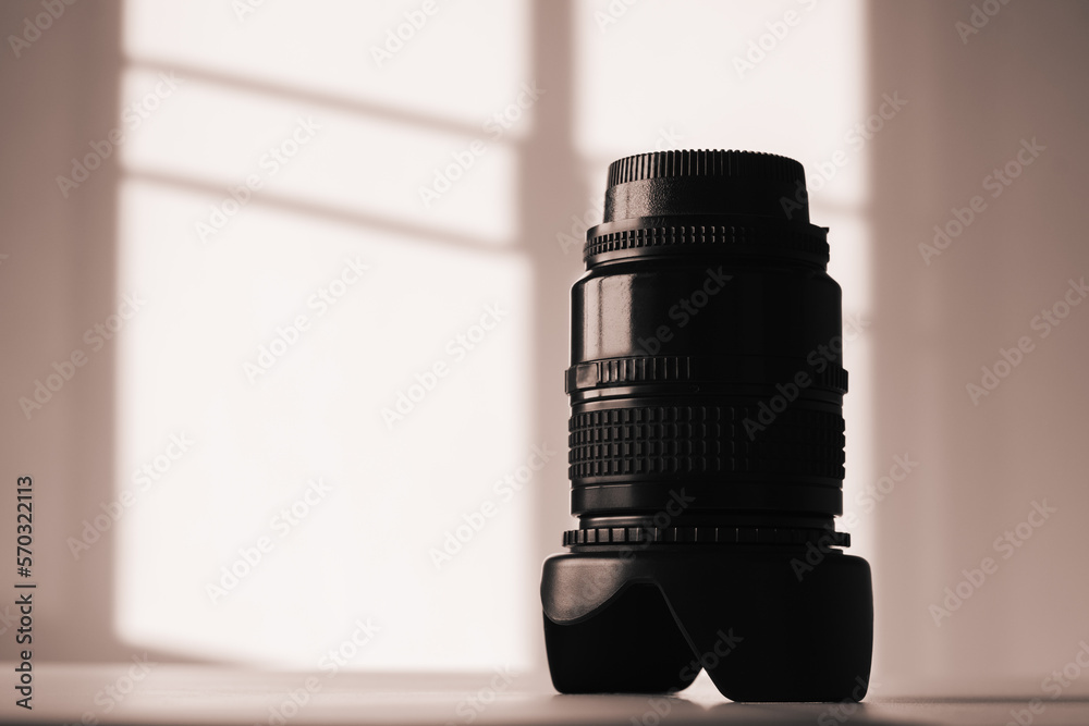 Camera lens isolated on blurred light and shadow from window background ...