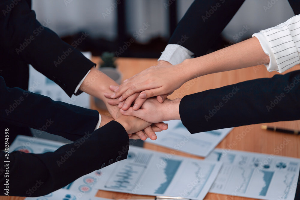 Top view closeup business team of suit-clad businesspeople join hand stack together. Colleague ...