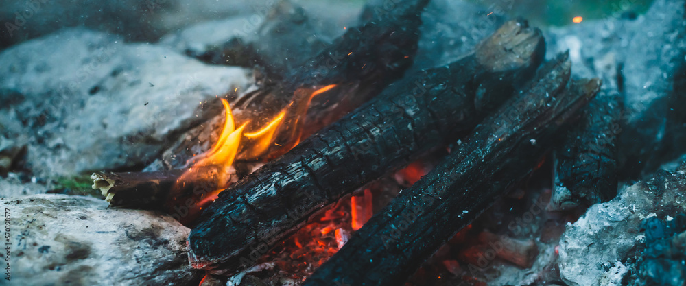 Vivid smoldered firewoods burned in fire close-up. Atmospheric warm ...