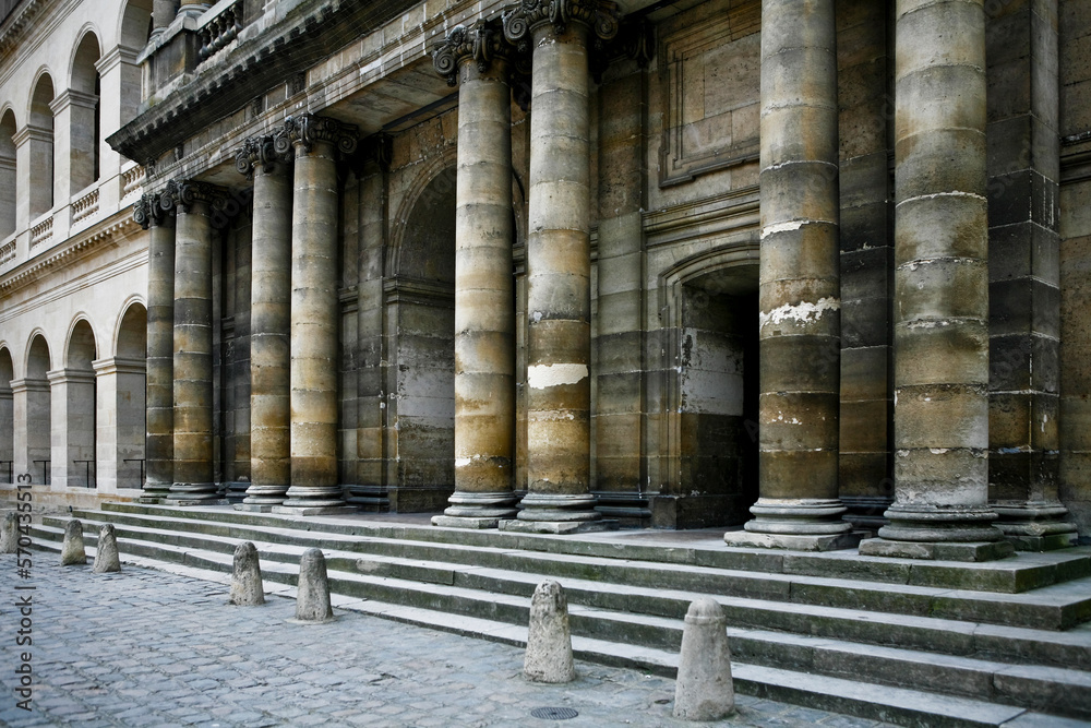 Paris ancient stone building colonnade with massive columns, arches and ...