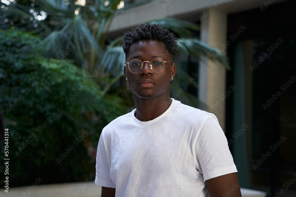 Portrait of serious black man, concentrating and looking at camera ...