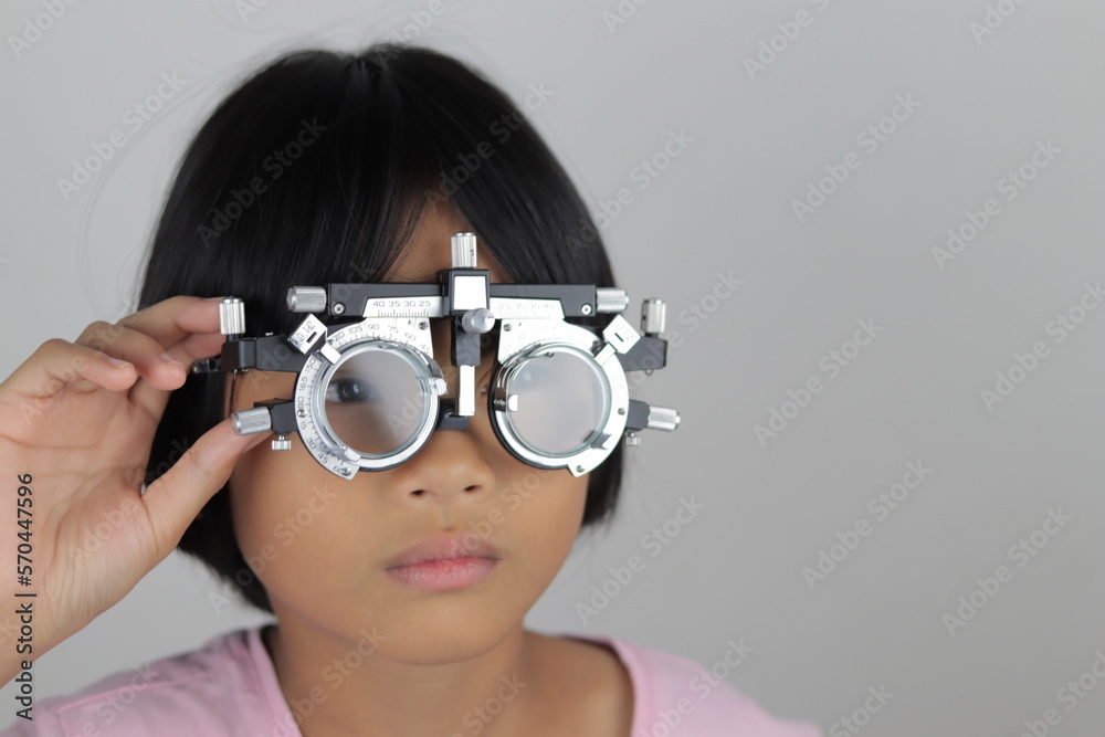 Eye exam, Elementary school girl wearing eyeglasses visual acuity test ...