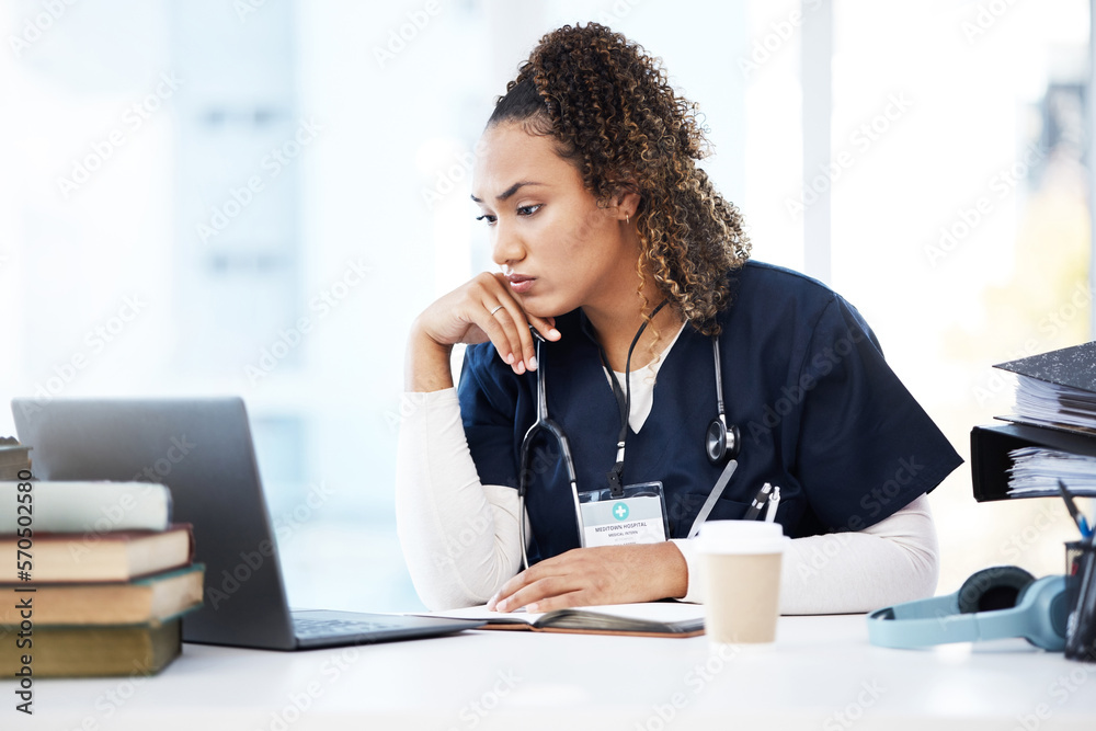 Healthcare, laptop and research with a woman nurse reading information ...