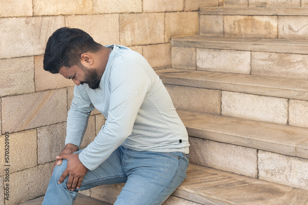 South Asian man falling down from stair, hurting his leg and knee joint ...