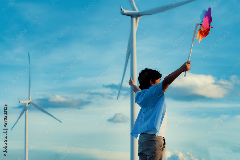 Progressive young asian boy playing with wind pinwheel toy in the wind ...