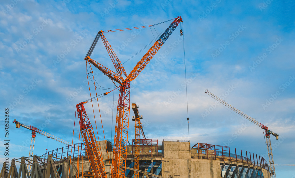Construction site. Construction cranes and a building under ...
