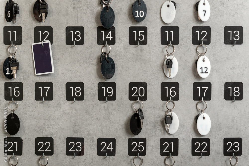 Lots of keys with key fobs and numbers. Keys to hotel rooms or luggage ...