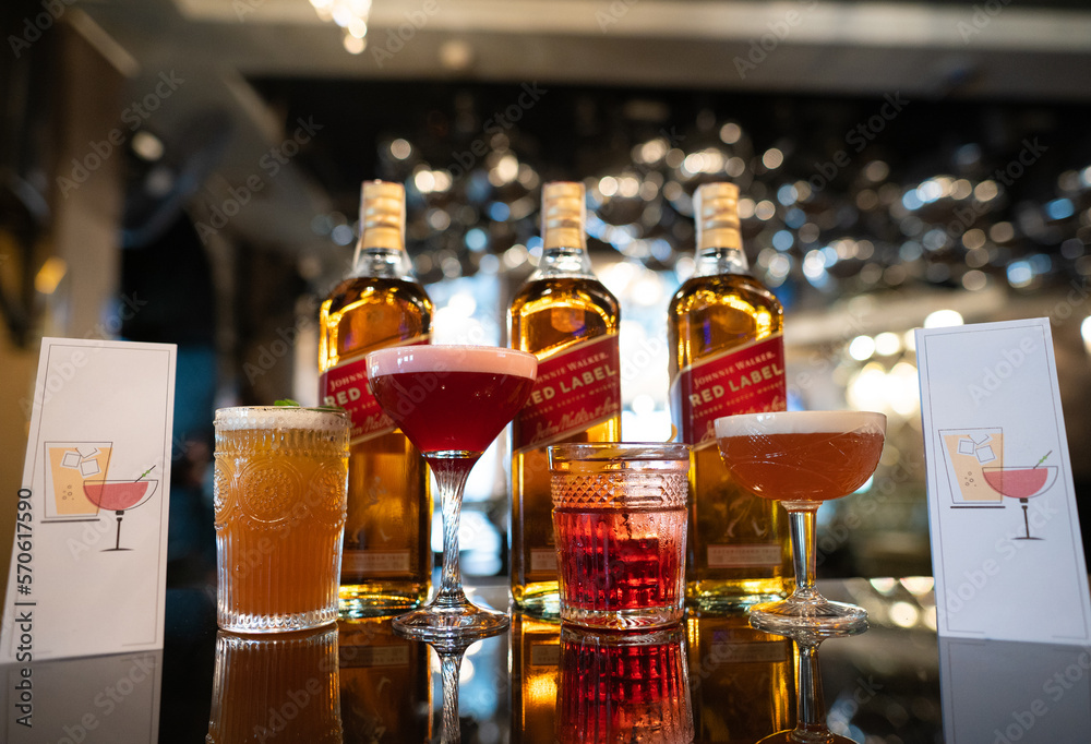 Johnnie Walker Red Label, three glass bottles and alcoholic cocktails ...