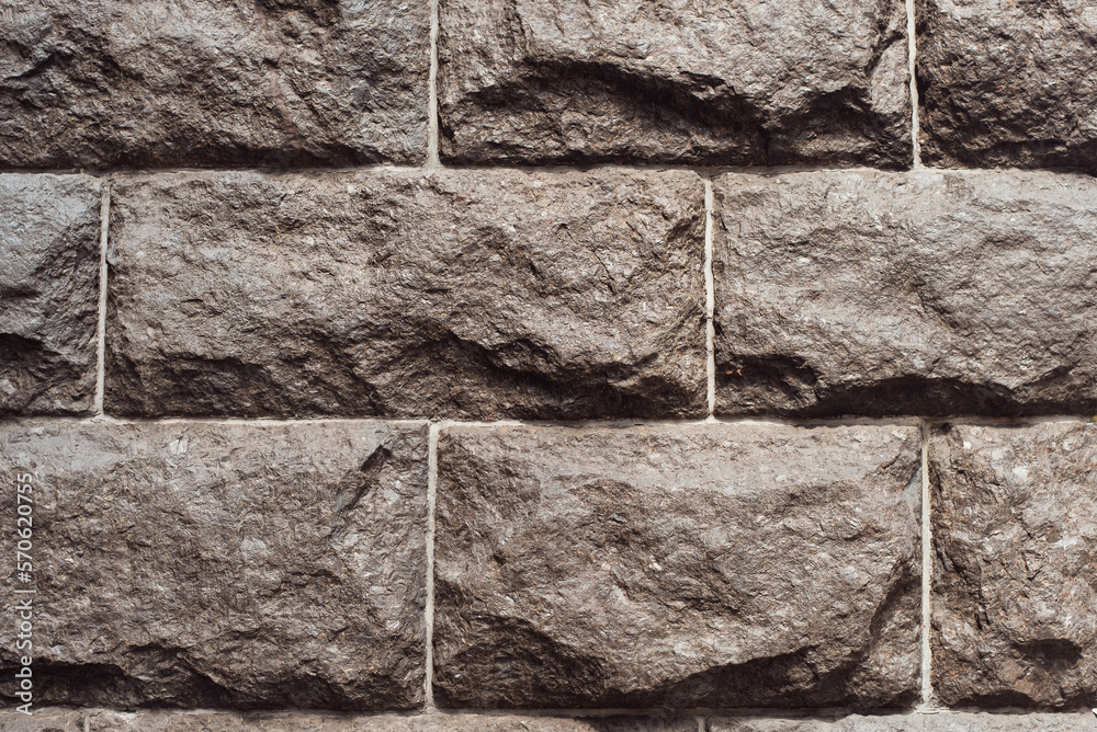 Facade of an ancient house made of large hewn stones, close-up ...