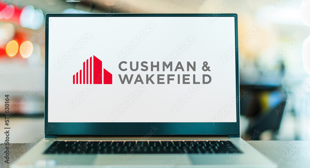 Laptop computer displaying logo of Cushman and Wakefield Stock Photo ...