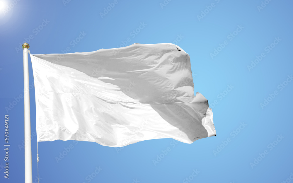 White flag on flagpole flying in the wind isolated on white peace ...