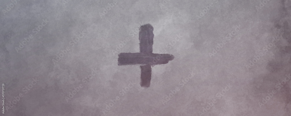Cross made from ashes. Symbolic of Ash Wednesday. On vintage gray ...