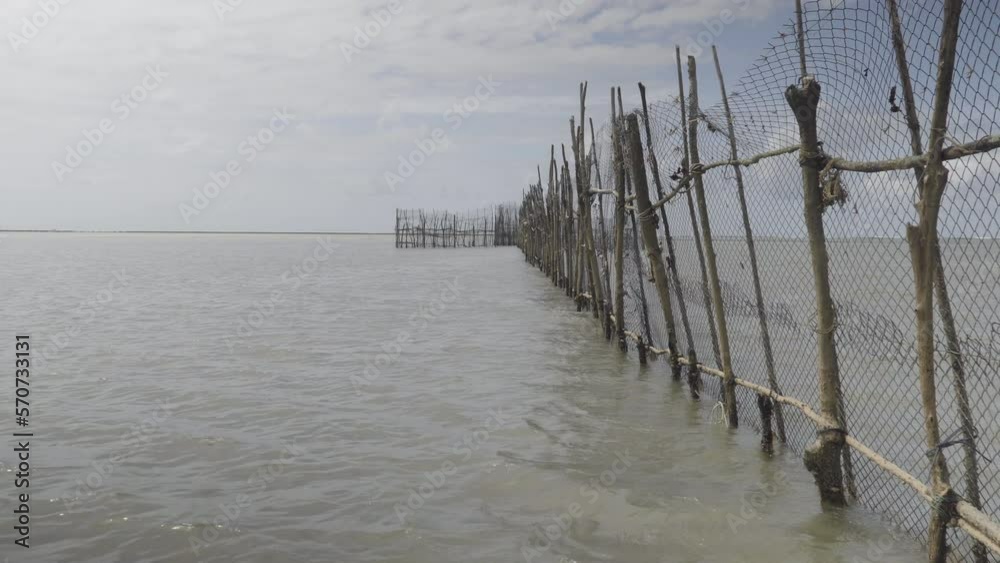 Rustic structure of fishing corrals shallow waters on the beach. Stock ...