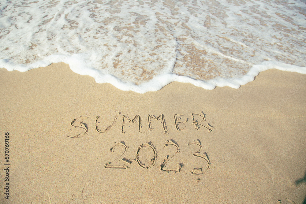 Summer 2023 lettering on the beach with wave and clear blue sea. Stock ...