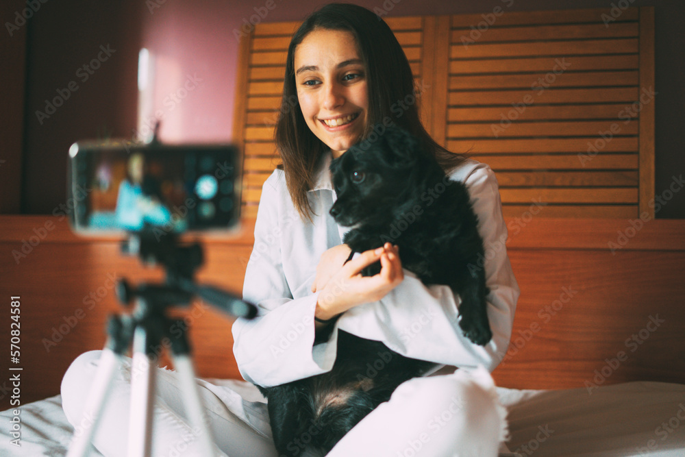 Veterinary surgeon filming a video with a dog. Online veterinary. Stock ...